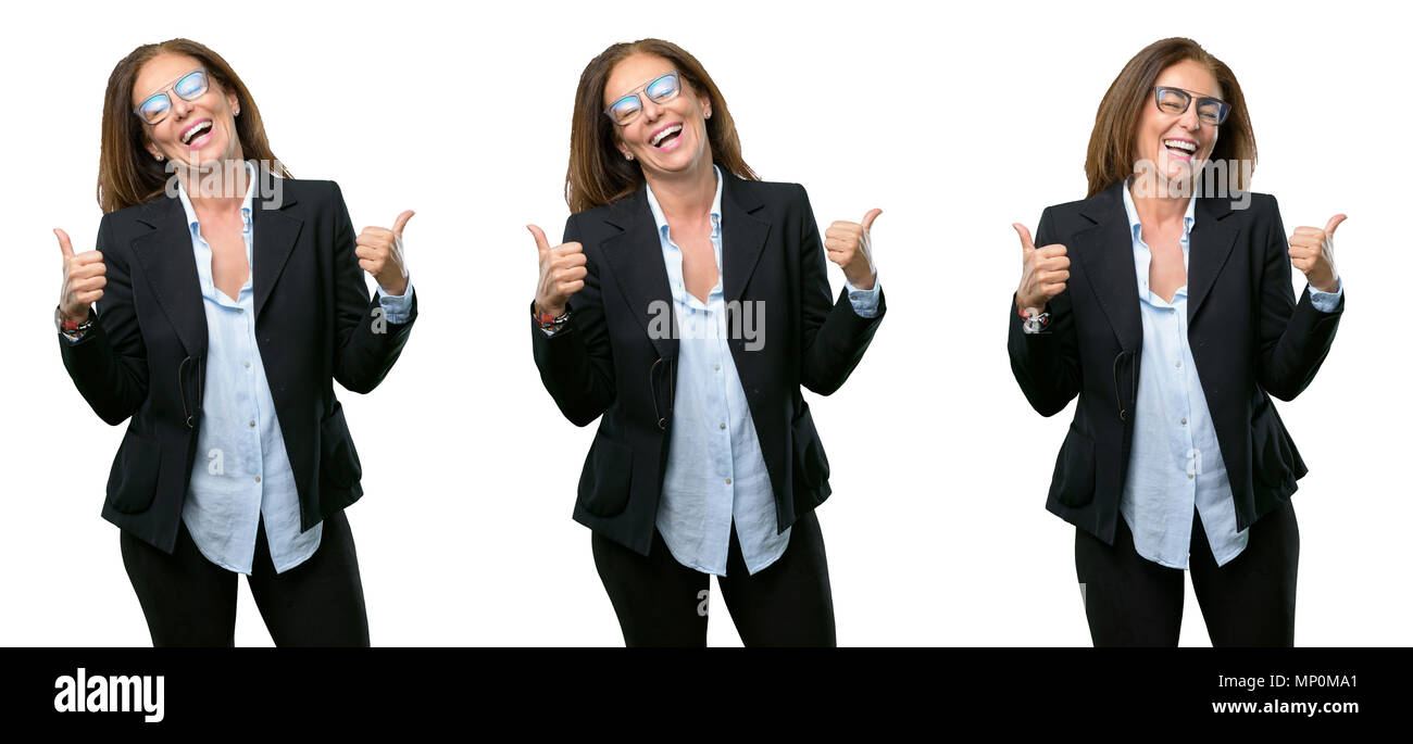 Middle age business woman smiling broadly showing thumbs up gesture to ...