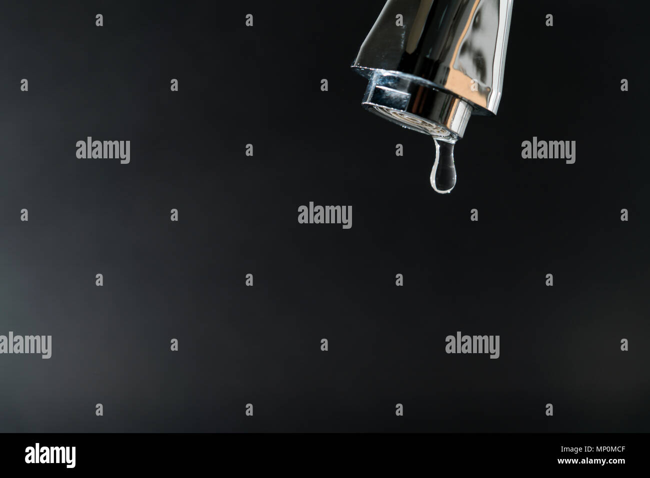 water drop on faucet with black backgrounds, world water day concept ...