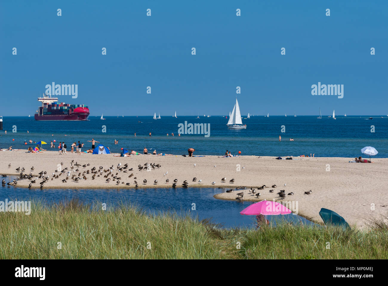 Relaxing at a hot summer day at the beach "Falkensteiner Strand", a ...