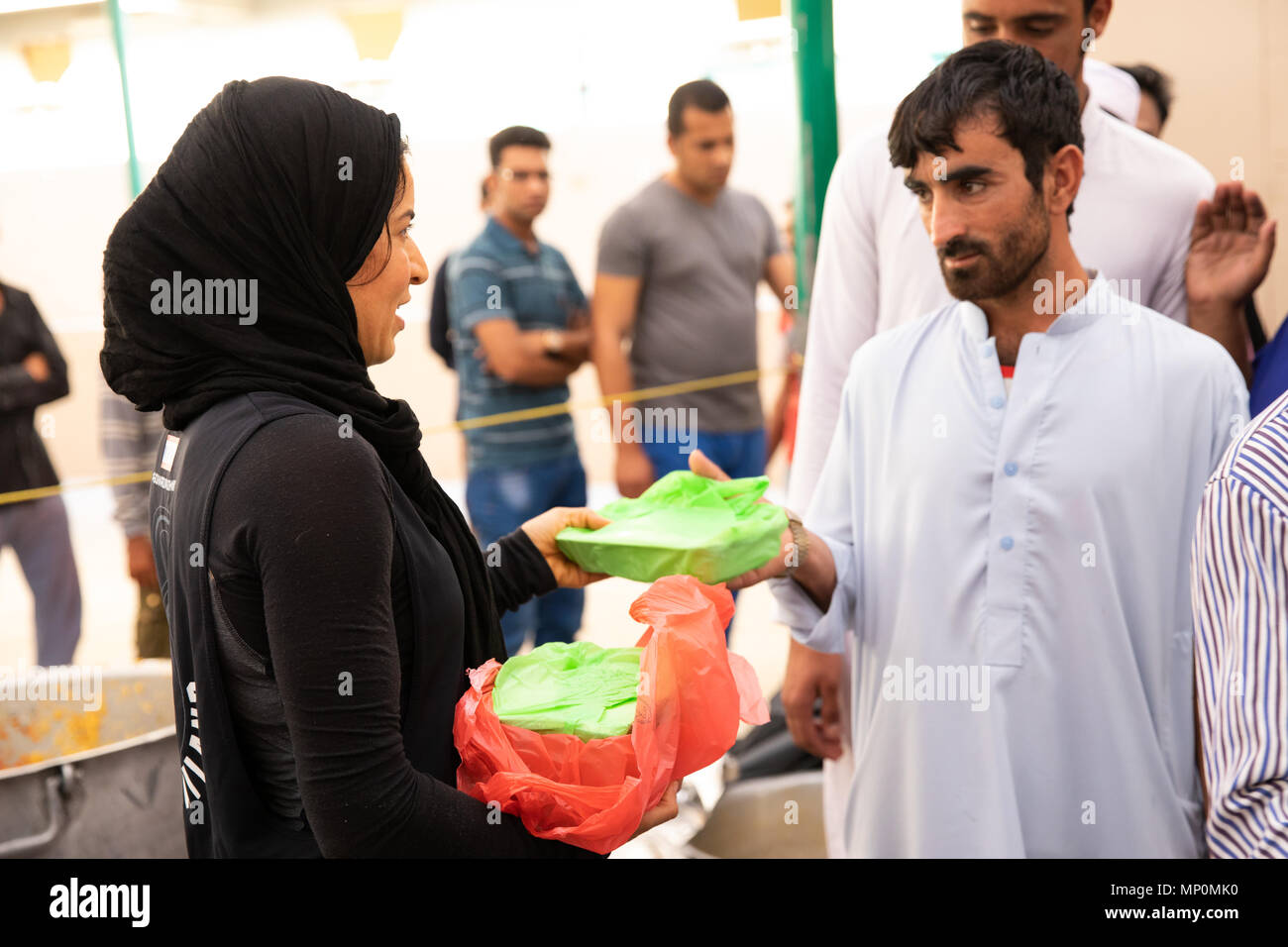 Dubai, UAE - May 18, 2018: Volunteers distributing food packages to ...