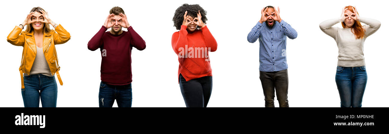 Group of cool people, woman and man looking at camera through fingers ...