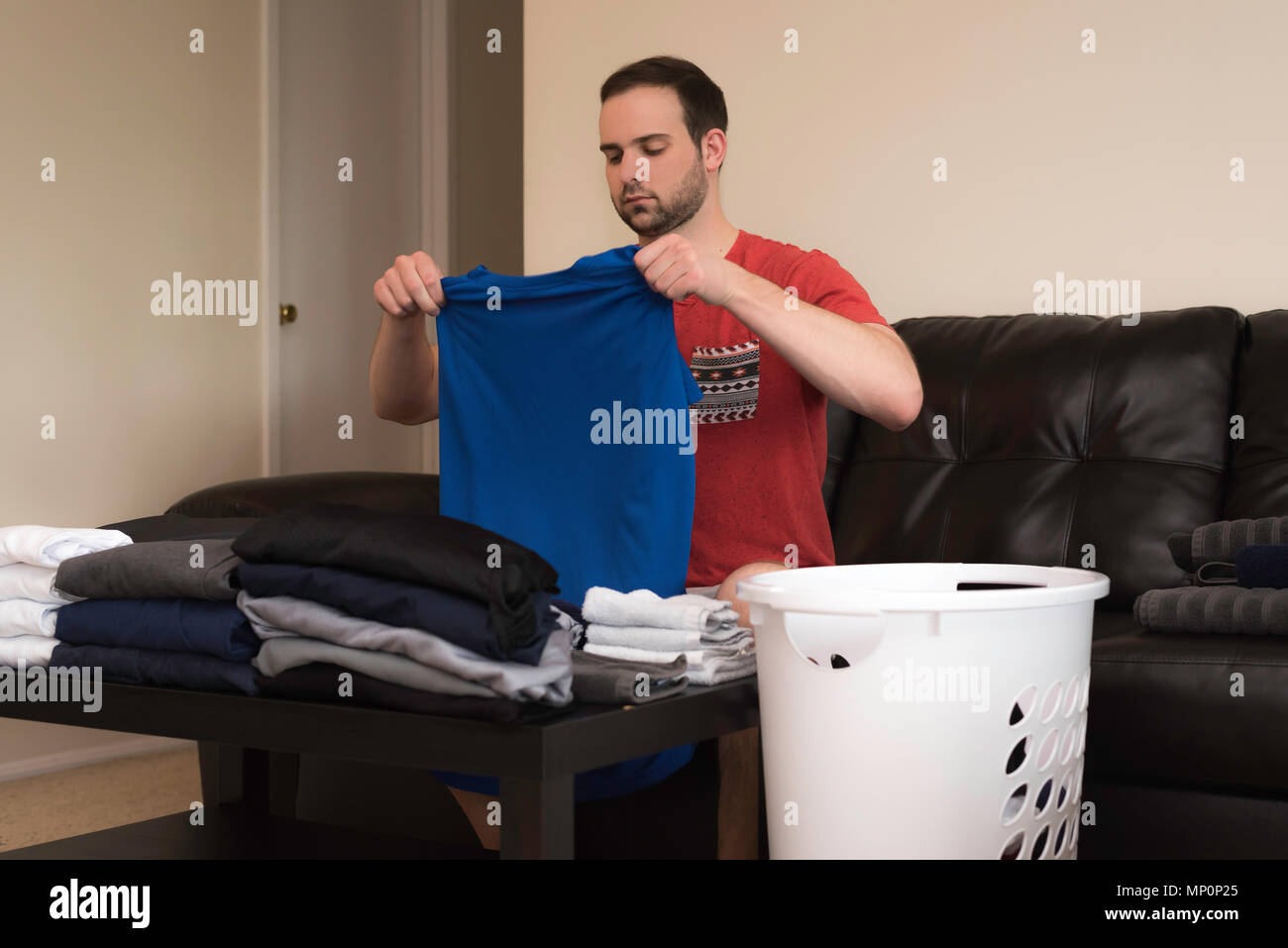 Man folding laundry hi-res stock photography and images - Alamy