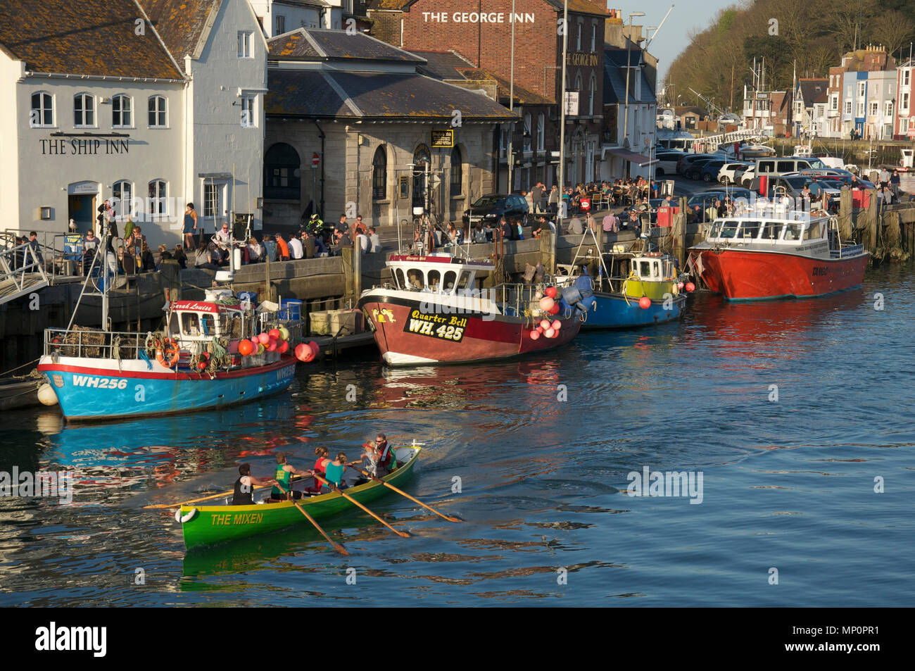 Fishing boats moored alongside Custom House Quay in Weymouth, Dorset. A ...