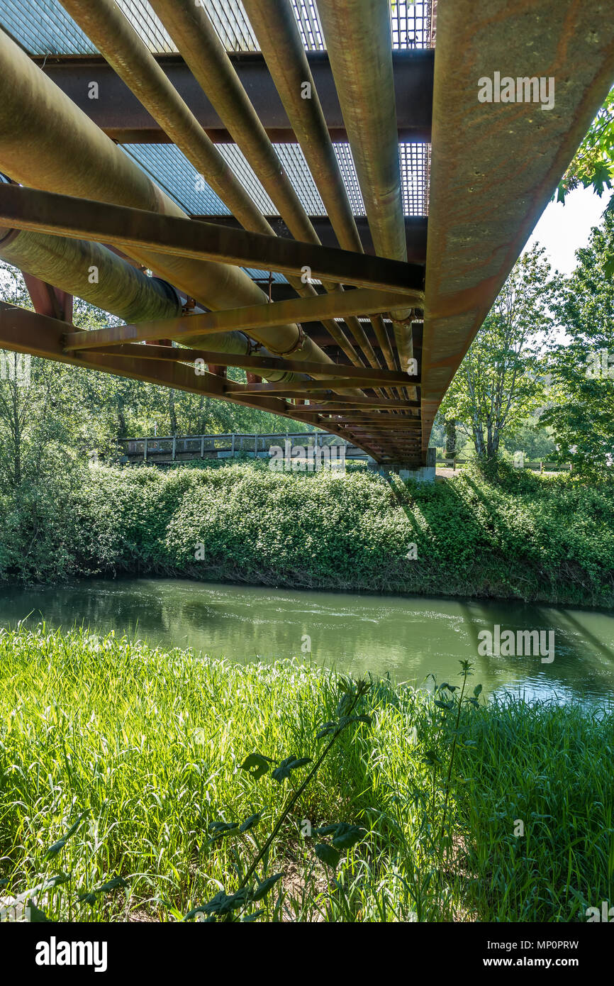 A view from beneath a rusty metal walking bridge that spans the Green ...