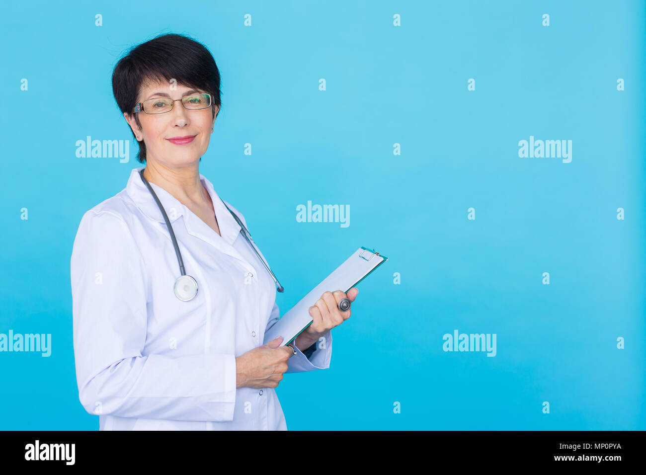 Medical physician doctor woman over blue background with copy space ...
