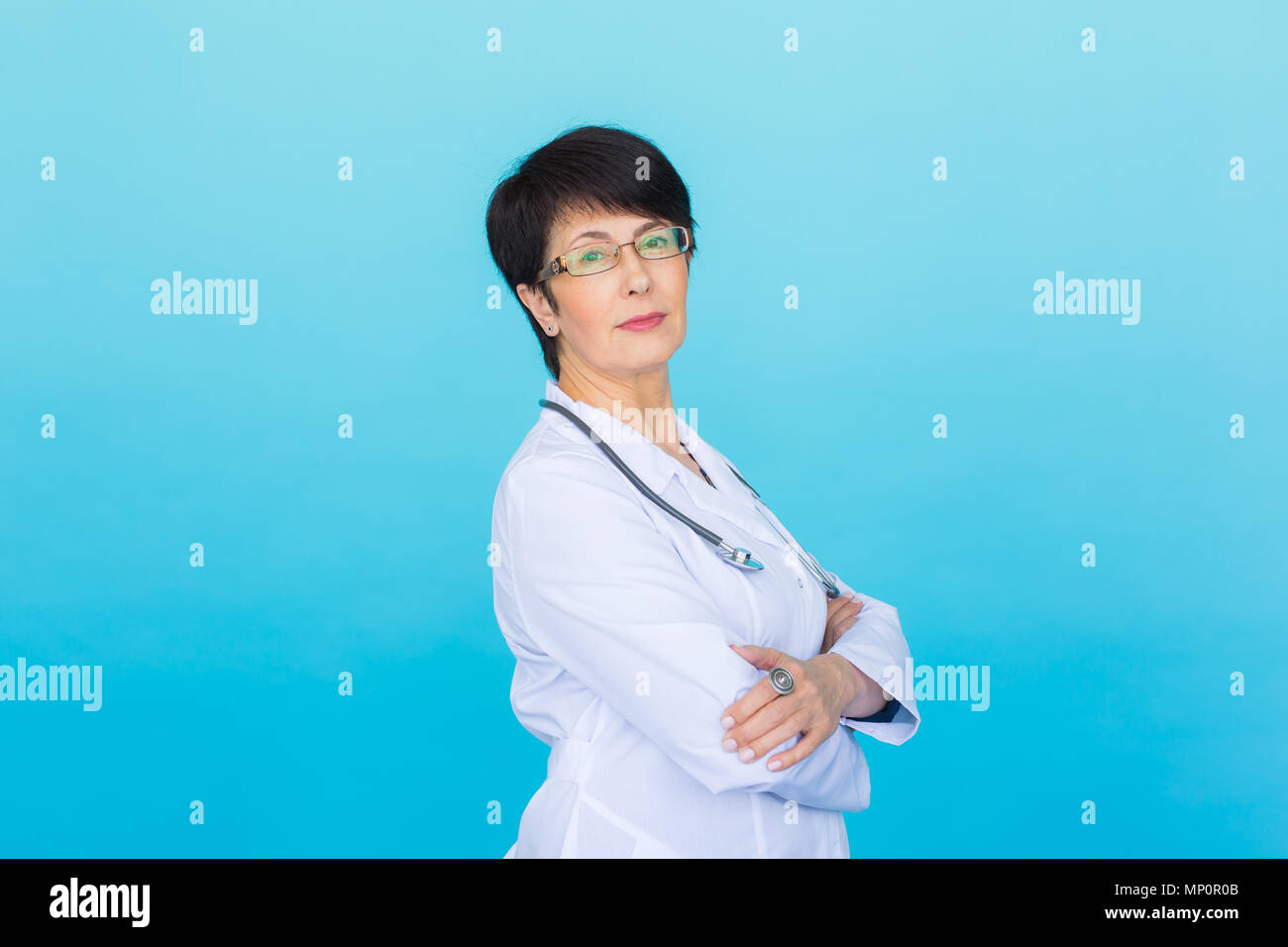 Doctor woman smile face with stethoscope over blue background Stock ...