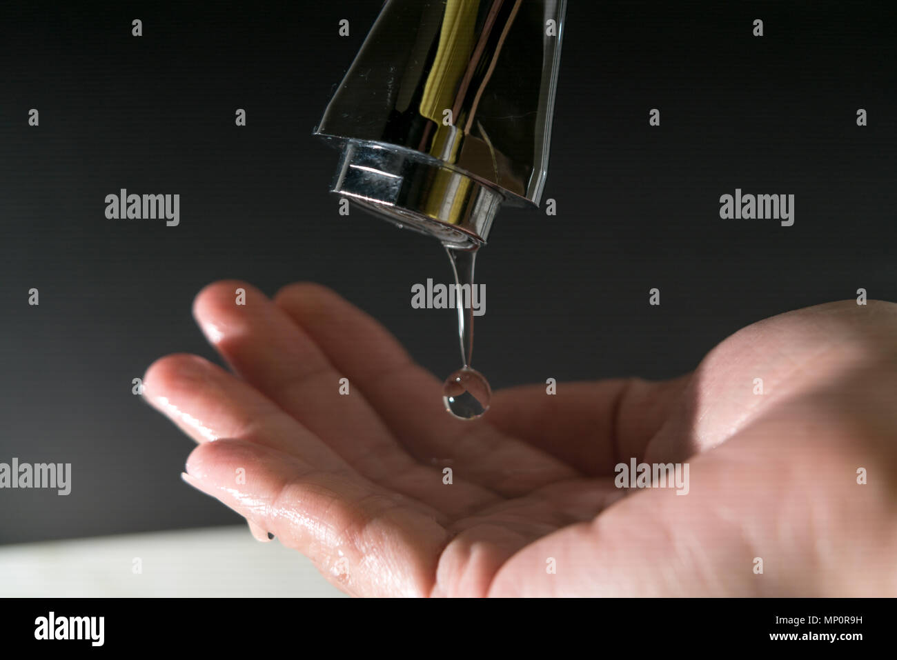 water drop on the faucet with black backgrounds, world water day ...