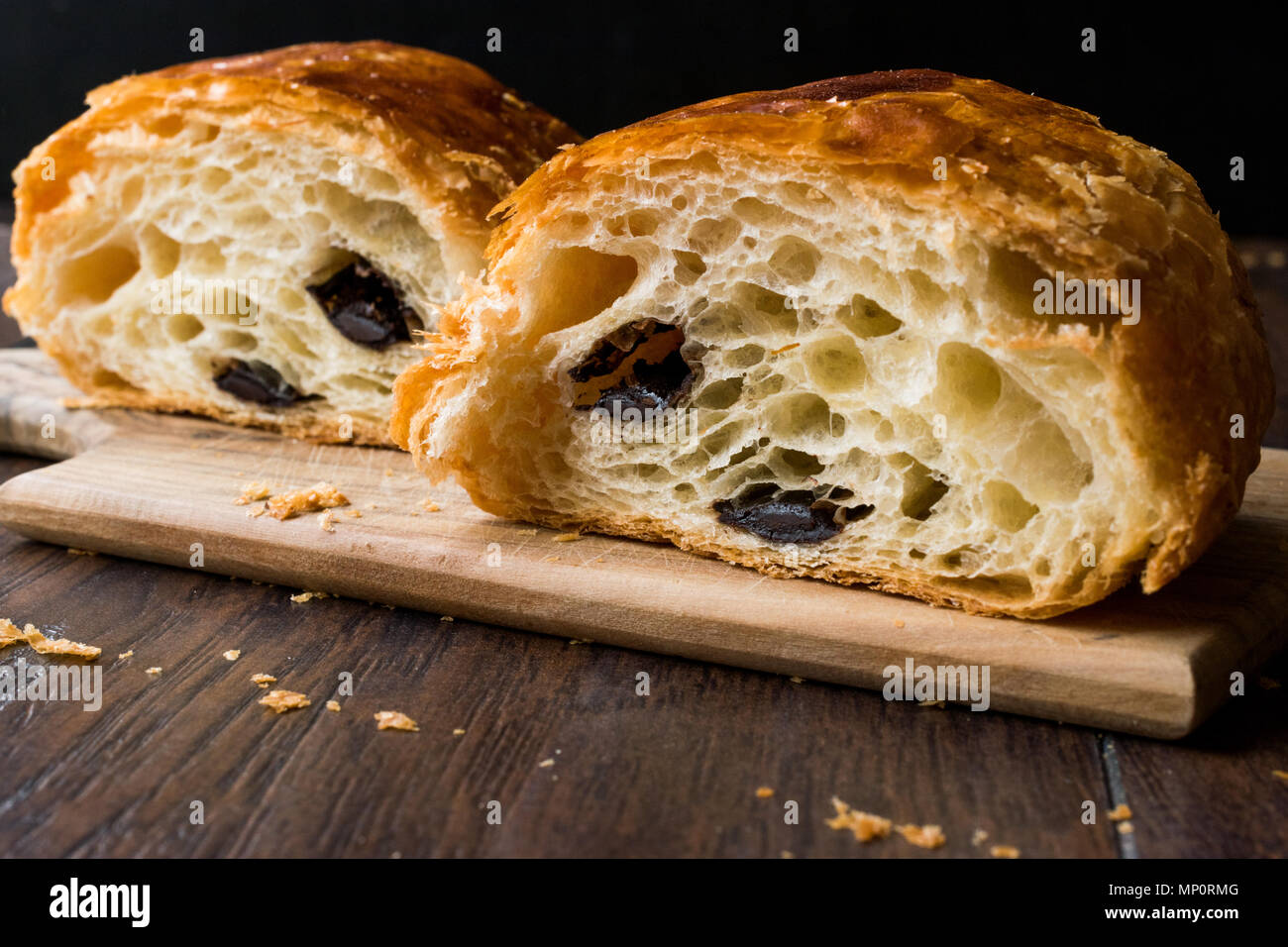 Freshly Baked Chocolate Croissant Half Cut with Knife. Bakery Concept ...
