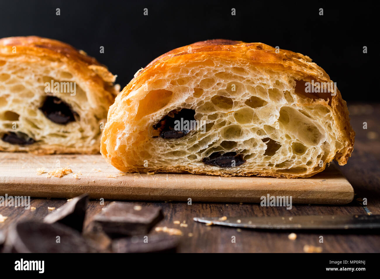 Freshly Baked Chocolate Croissant Half Cut with Knife. Bakery Concept ...