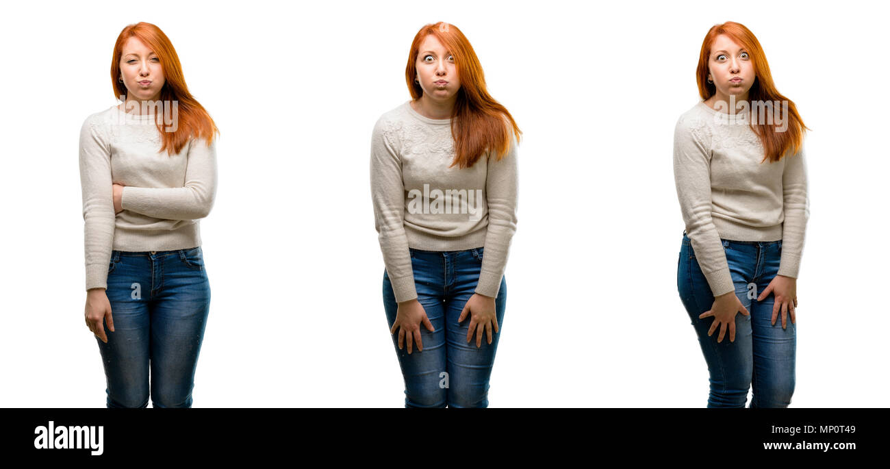 Young Beautiful redhead woman puffing out cheeks, having fun making ...
