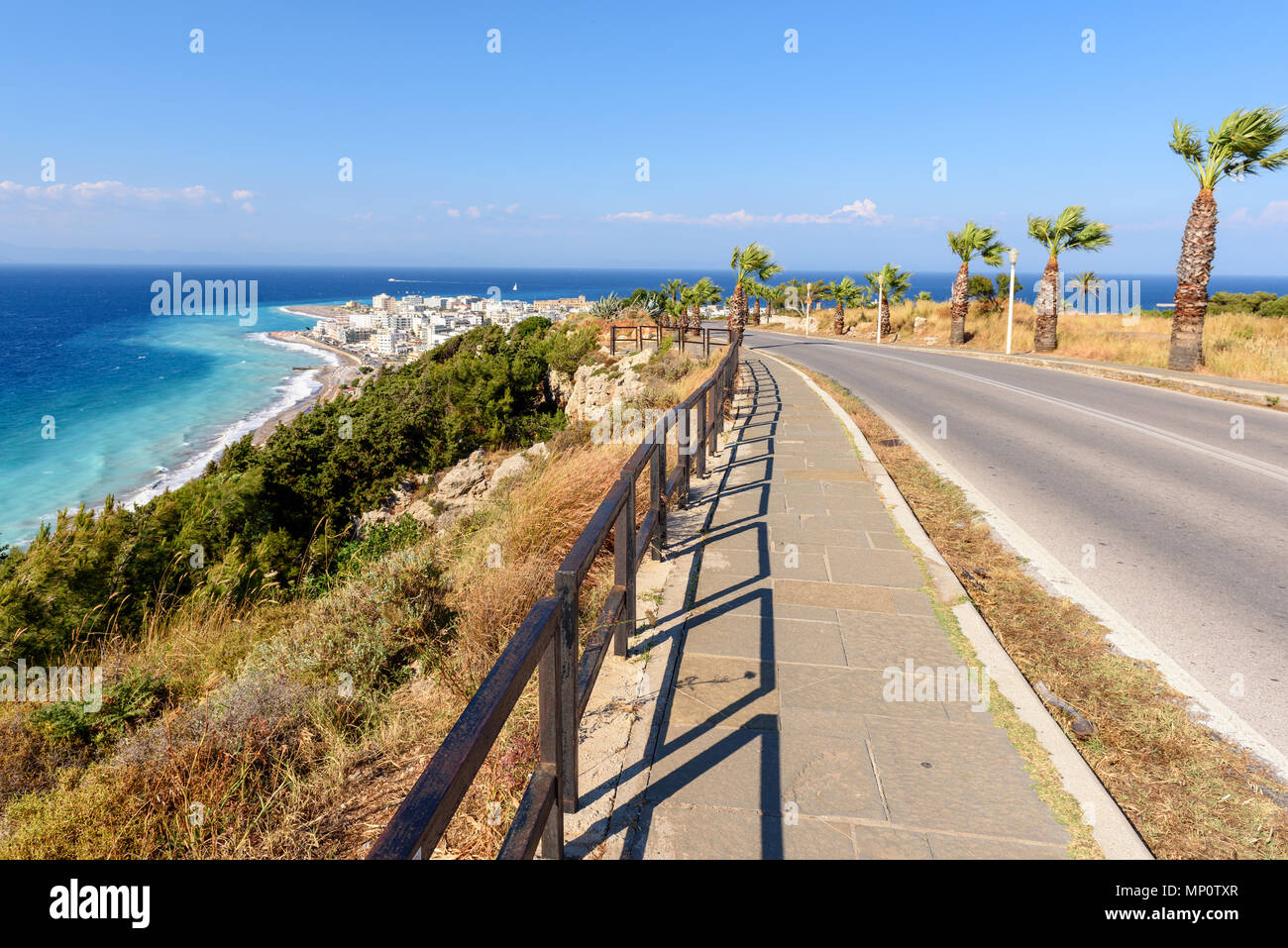 Coastal promenade and road with view of beautiful Rhodes bay. Greece ...