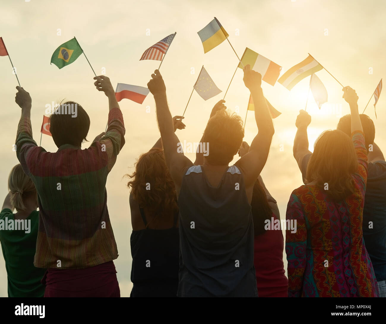 Group of people holding different flags Stock Photo - Alamy