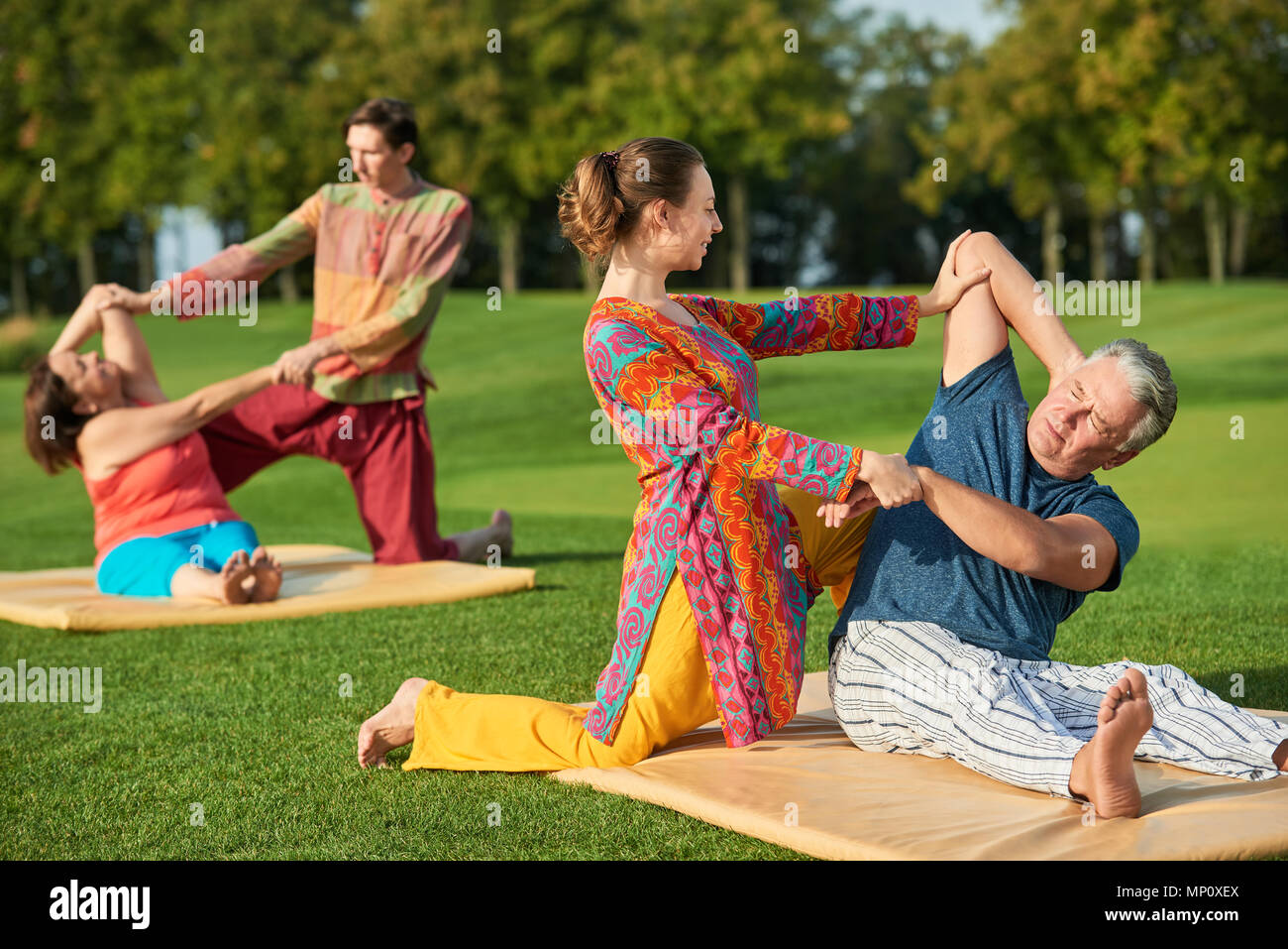 People making yoga exercises outdoor Stock Photo - Alamy