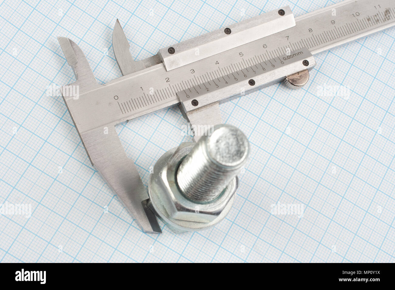 Screw, Nuts and caliper on graph paper background Stock Photo - Alamy