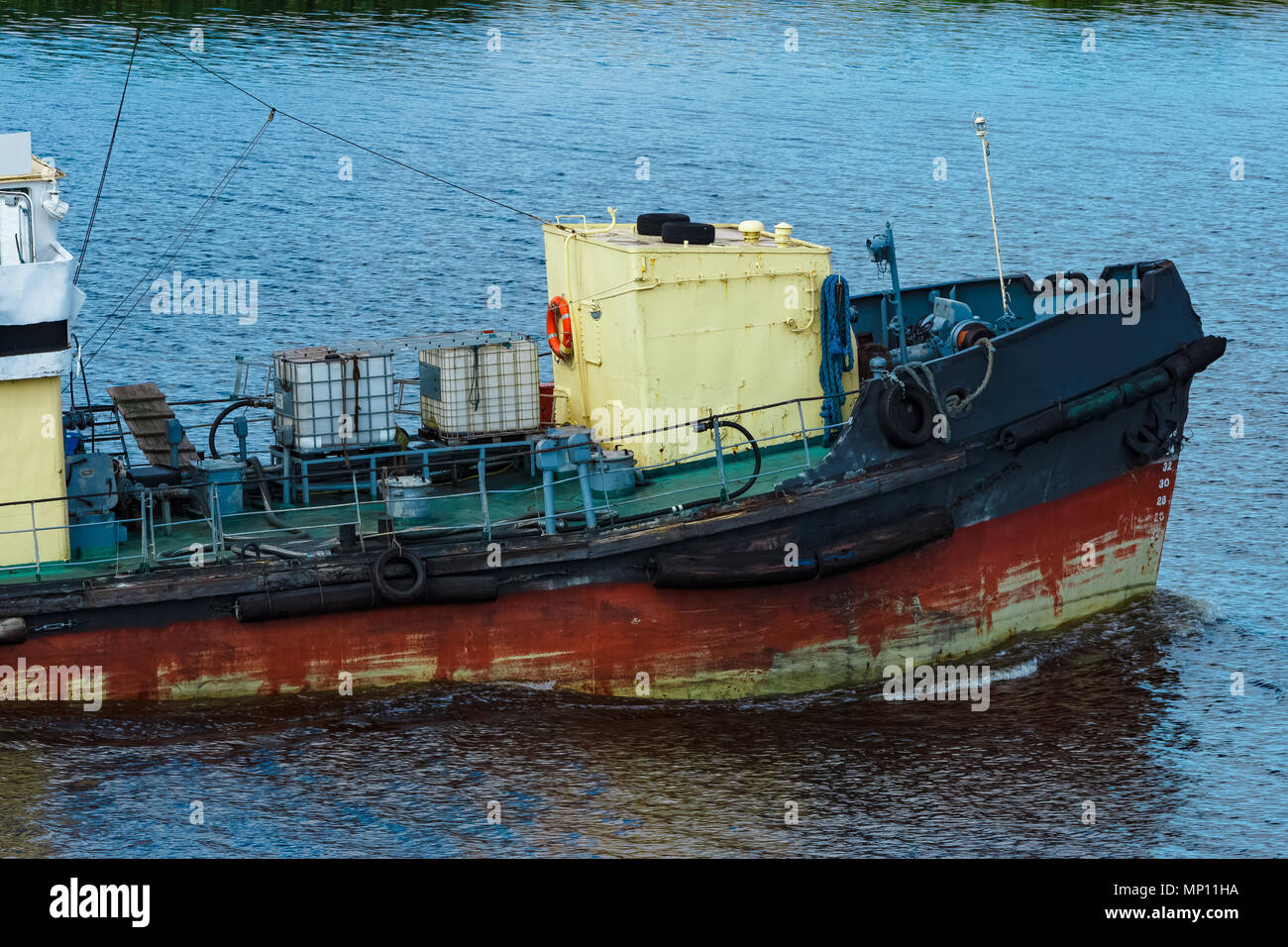 Old tug ship moving to the cargo terminal. Industrial service Stock ...