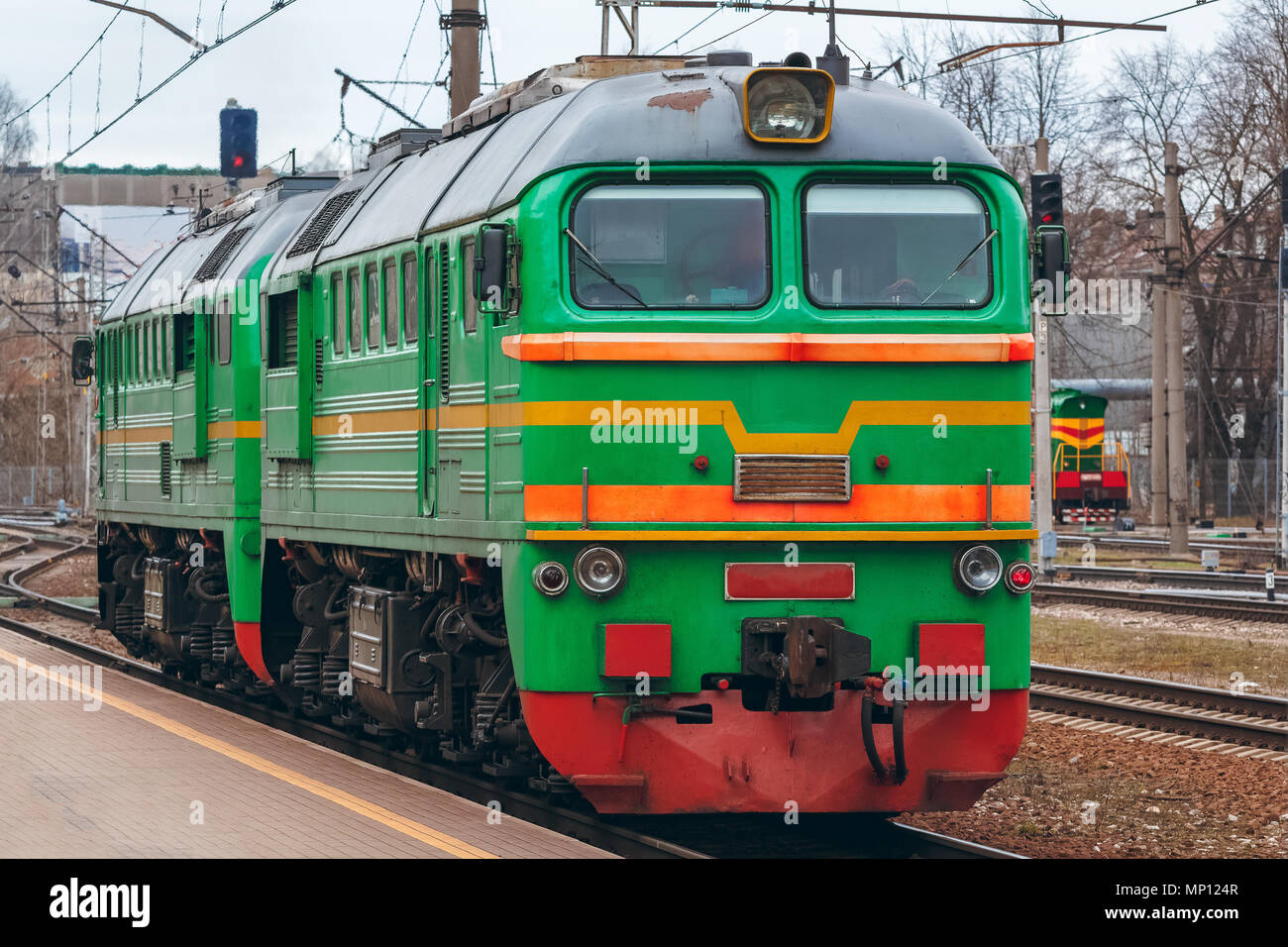 Green diesel cargo locomotive. Freight train in action Stock Photo - Alamy