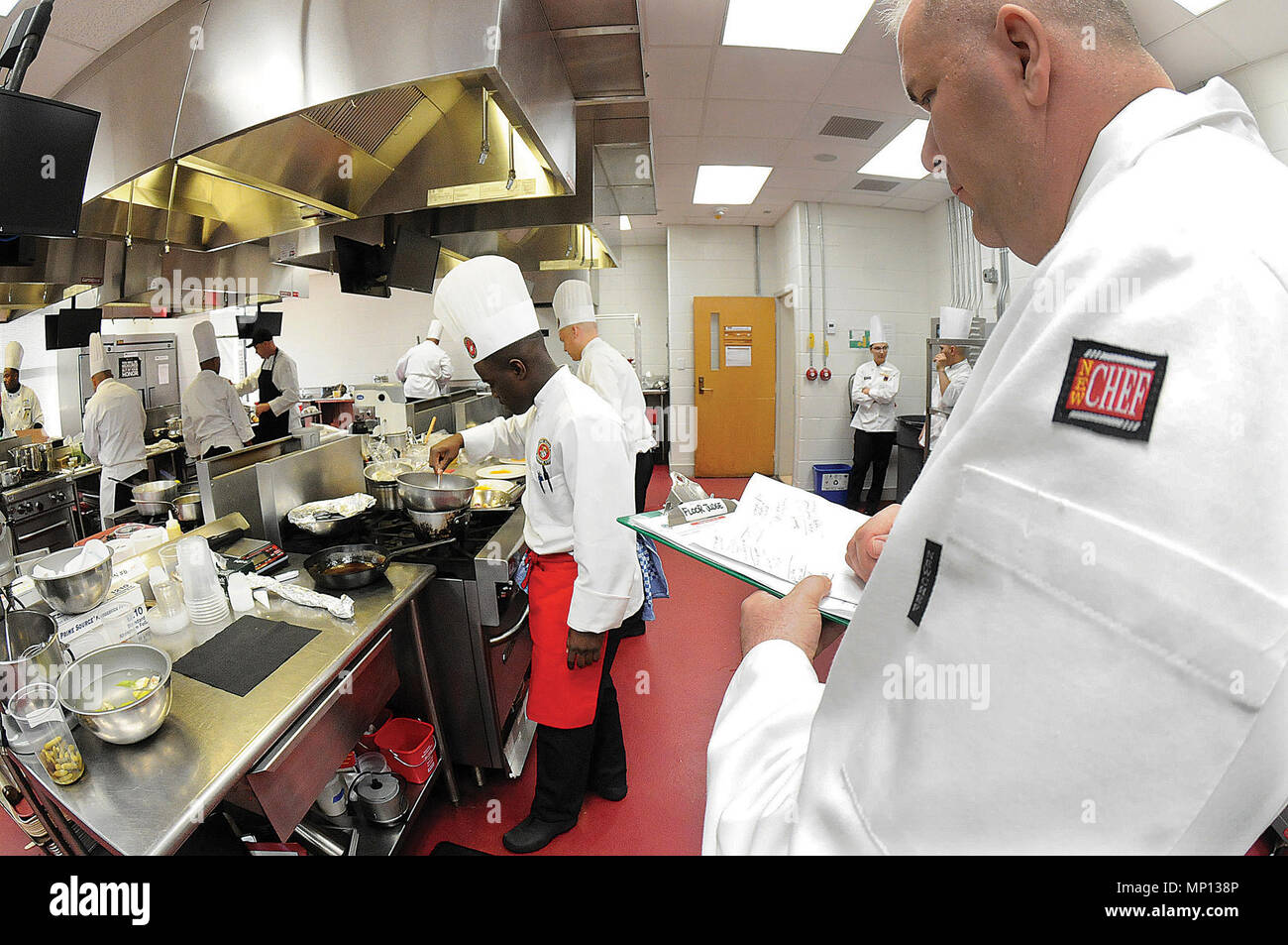 American Culinary Federation Judge Brandon Parry looks over contestants ...