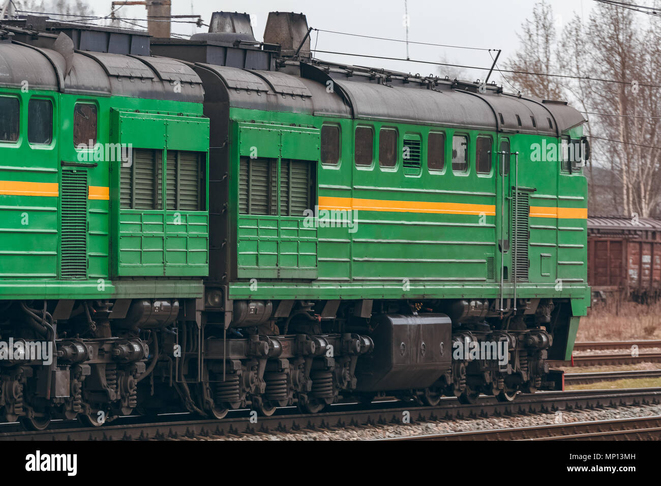 Green diesel cargo locomotive. Freight train in action Stock Photo - Alamy