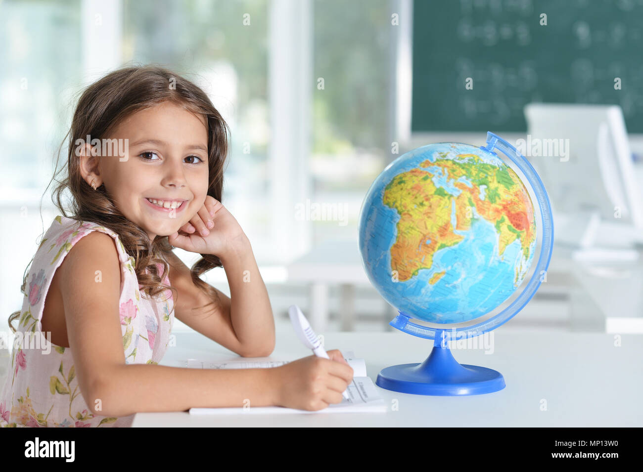 Cute little girl doing homework Stock Photo - Alamy