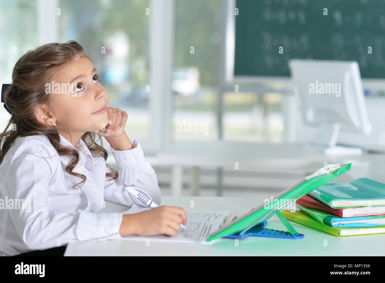 Cute little girl doing homework Stock Photo - Alamy