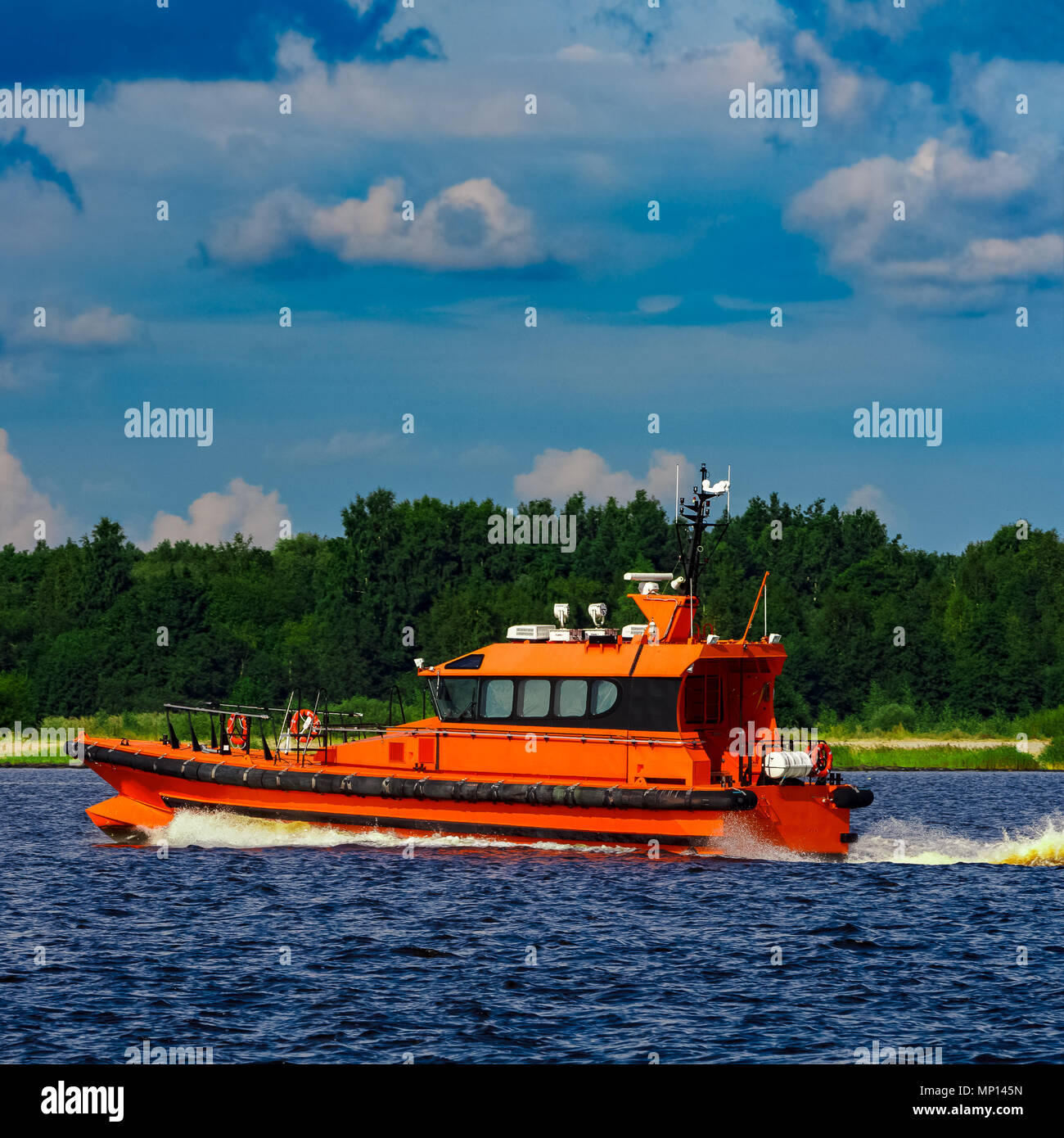 Orange pilot boat moving by the river in Europe. Rescue service Stock ...