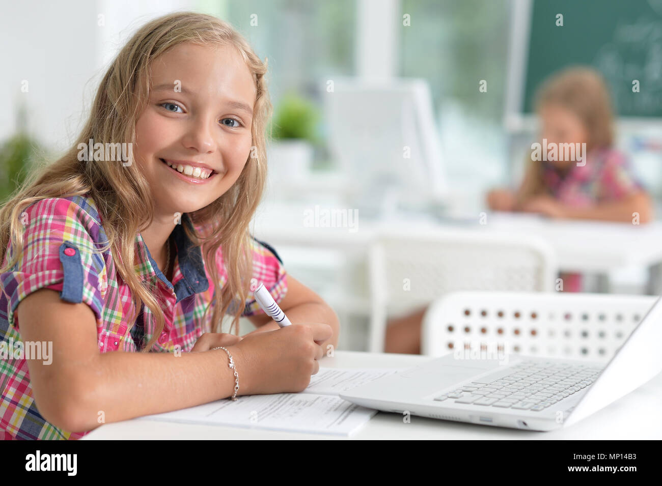 Cute little girl doing homework Stock Photo - Alamy