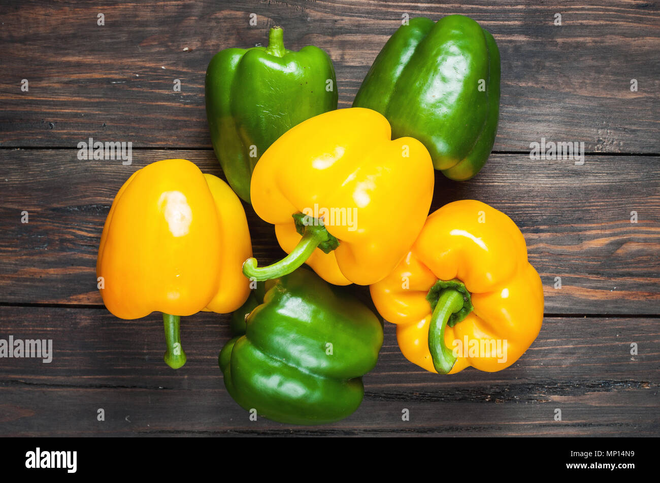 yellow and green paprika on wood background Stock Photo - Alamy