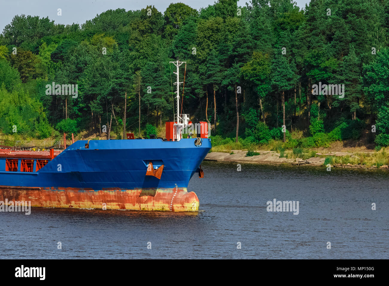 Blue cargo ship with long reach excavator moving to the port Stock ...