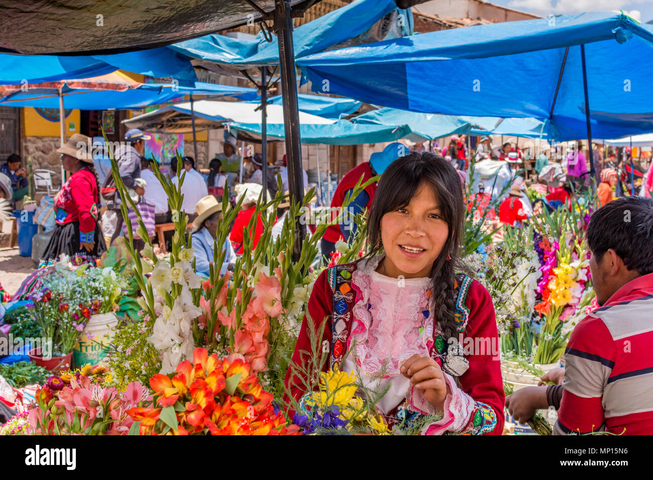 Pisac Peru Market, young Peruvian girl selling flowers at Pisac Market ...