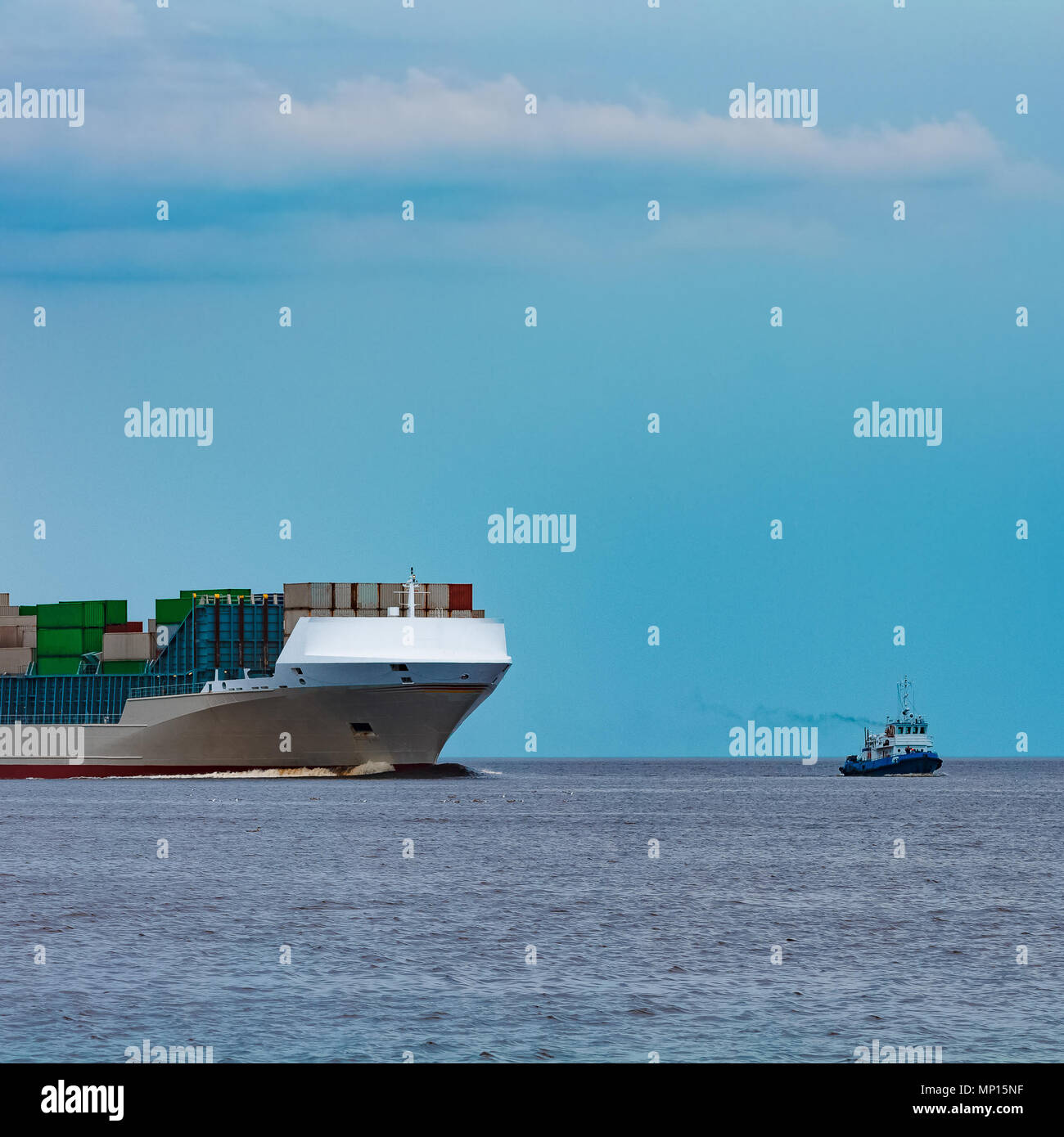 Grey container ship. Logistics and production import Stock Photo - Alamy