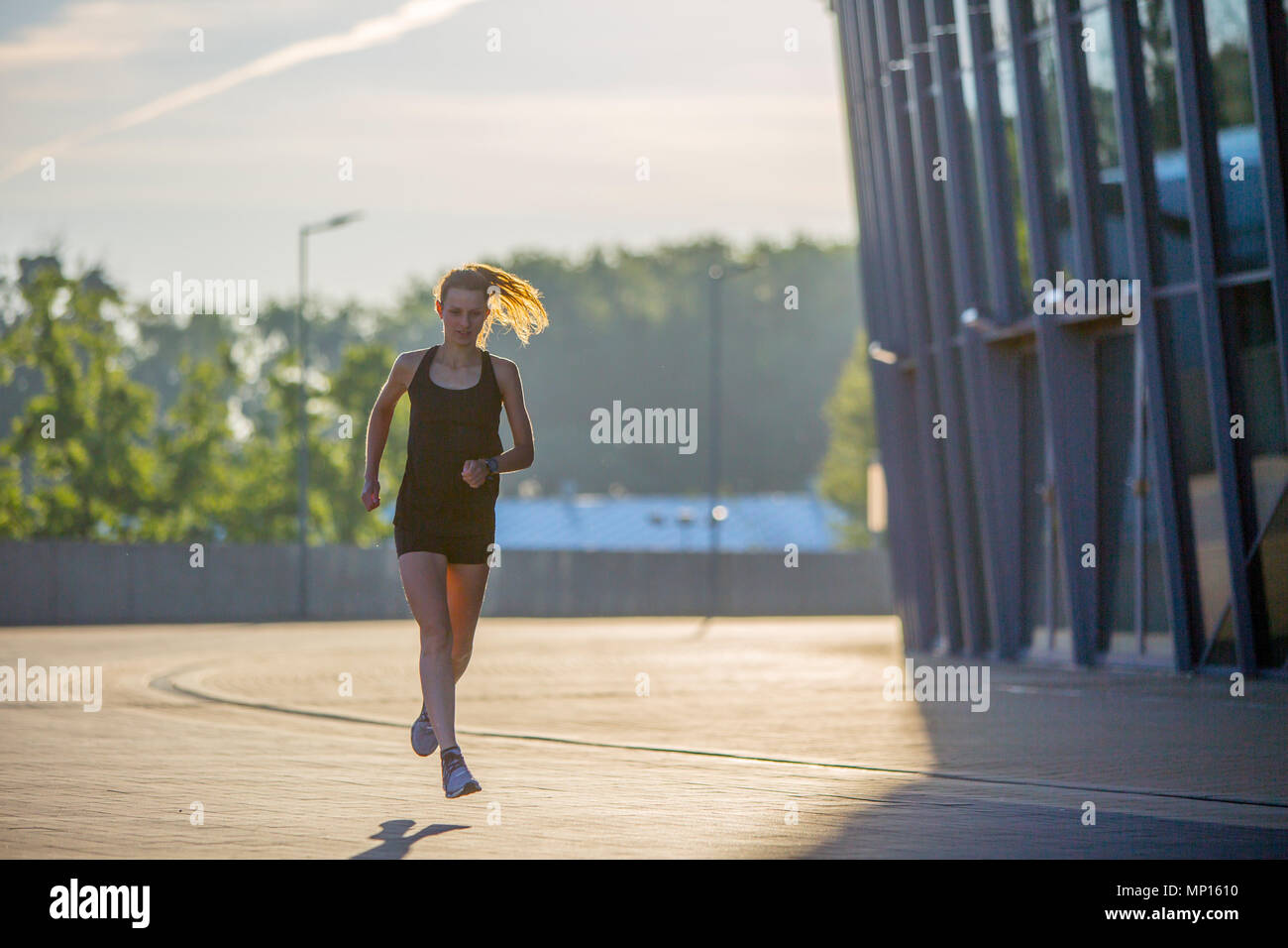 Woman "Urban Runner" having a morning run Stock Photo - Alamy