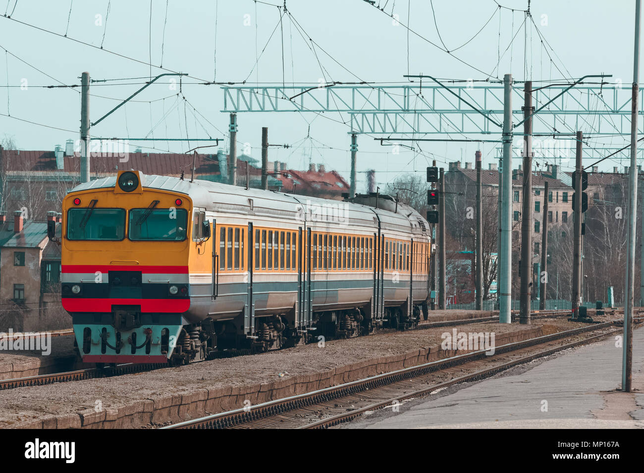 Old yellow passenger diesel train moving at the terminal Stock Photo ...