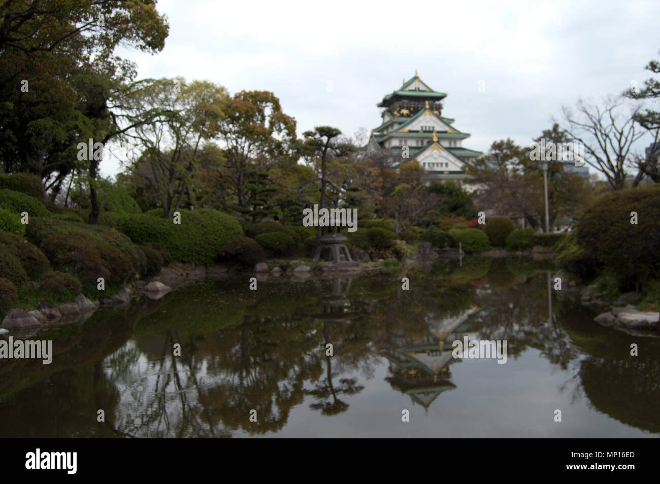Osaka castle with reflection in pond on a cloudy day, Osaka, Japan Stock Photo - Alamy