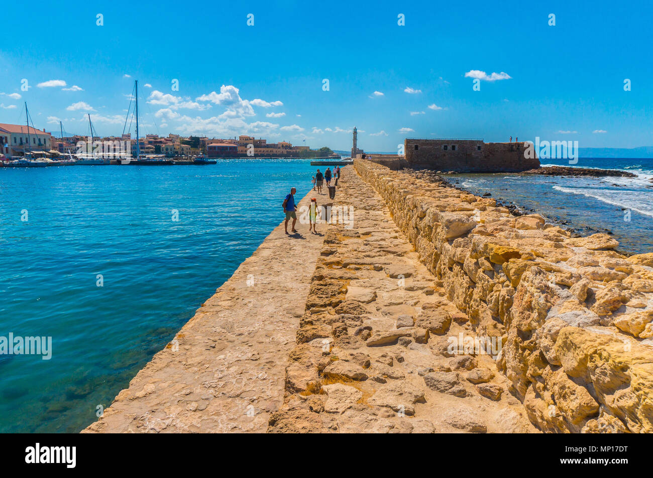 Pathway to the lighthouse of the old venetian port of Chania in Crete ...