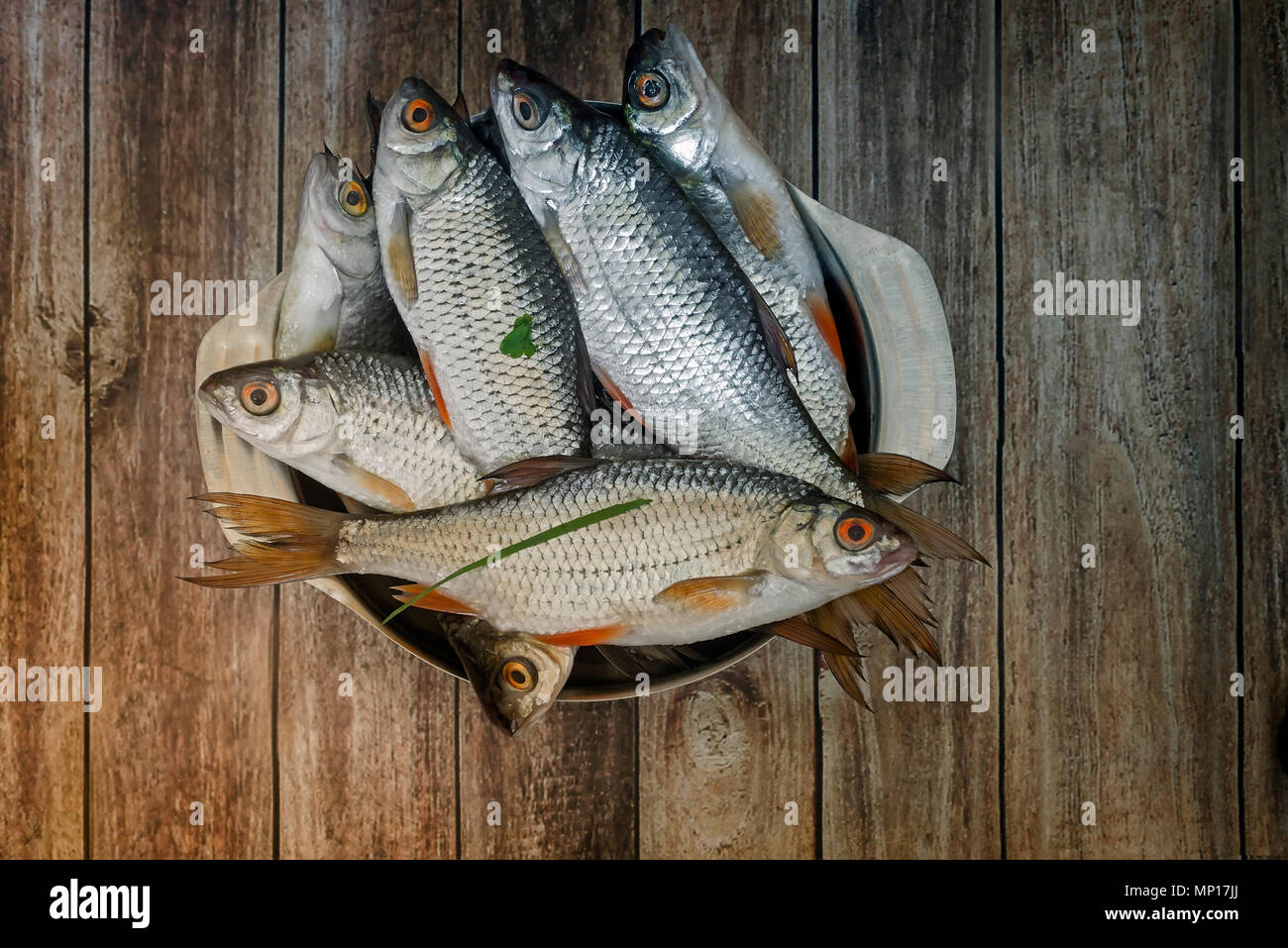 Fresh fish on the table in an iron bowl Stock Photo - Alamy