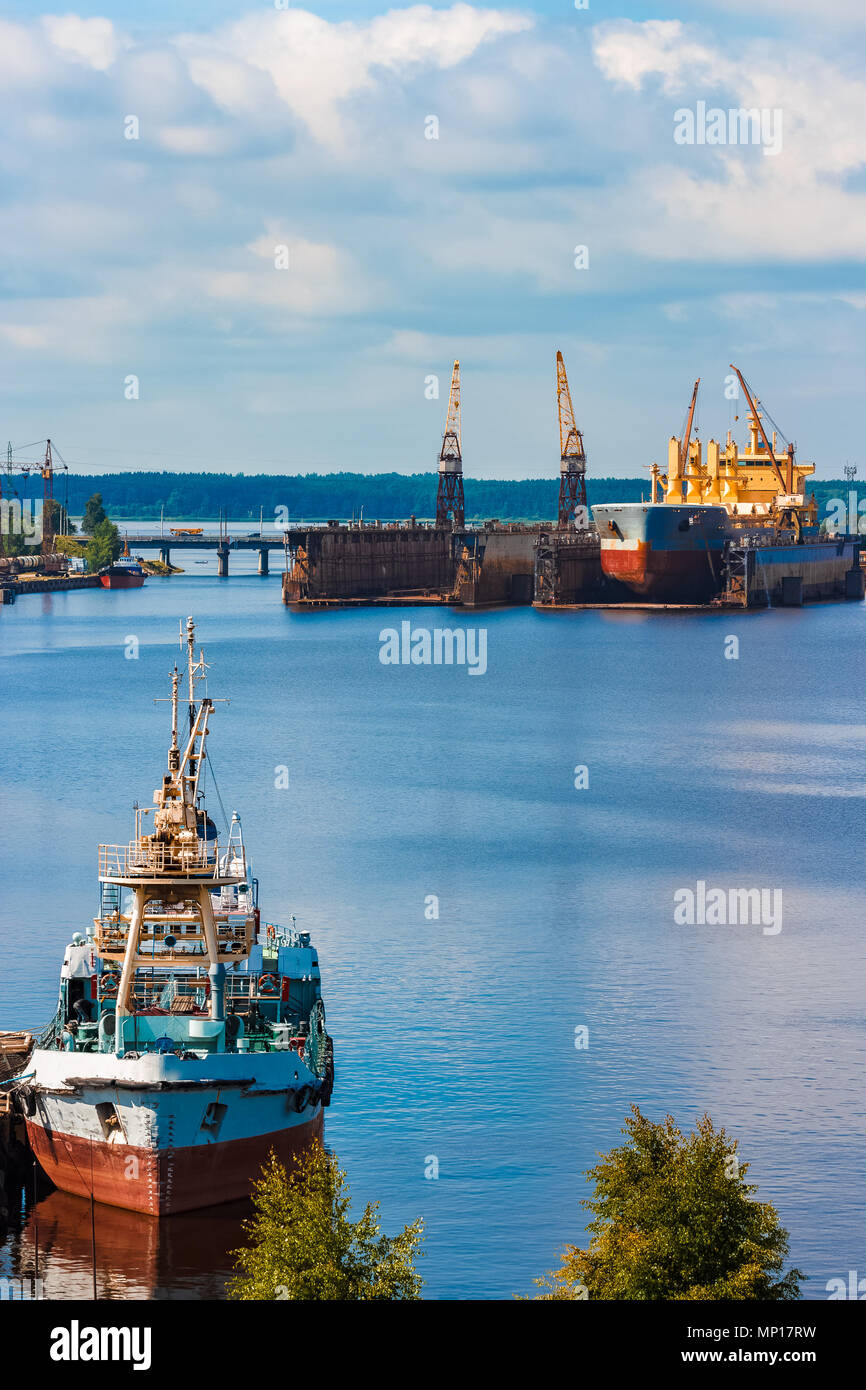 Yellow bulk carrier standing at the old shipyard in the dock Stock ...