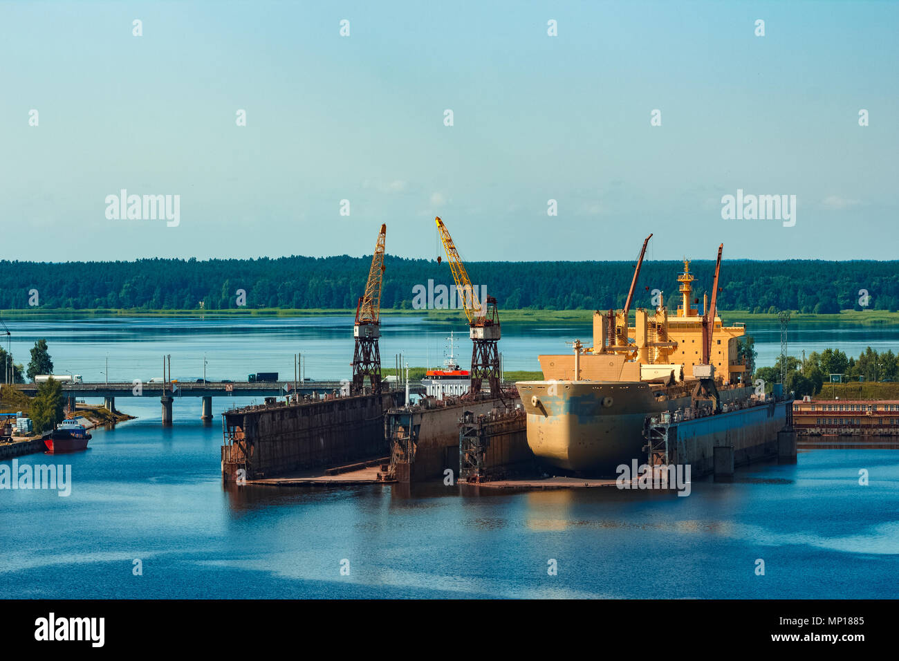 Yellow bulk carrier standing at the old shipyard in the dock Stock ...