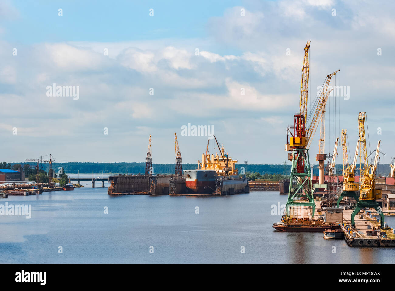Yellow bulk carrier standing at the old shipyard in the dock Stock ...