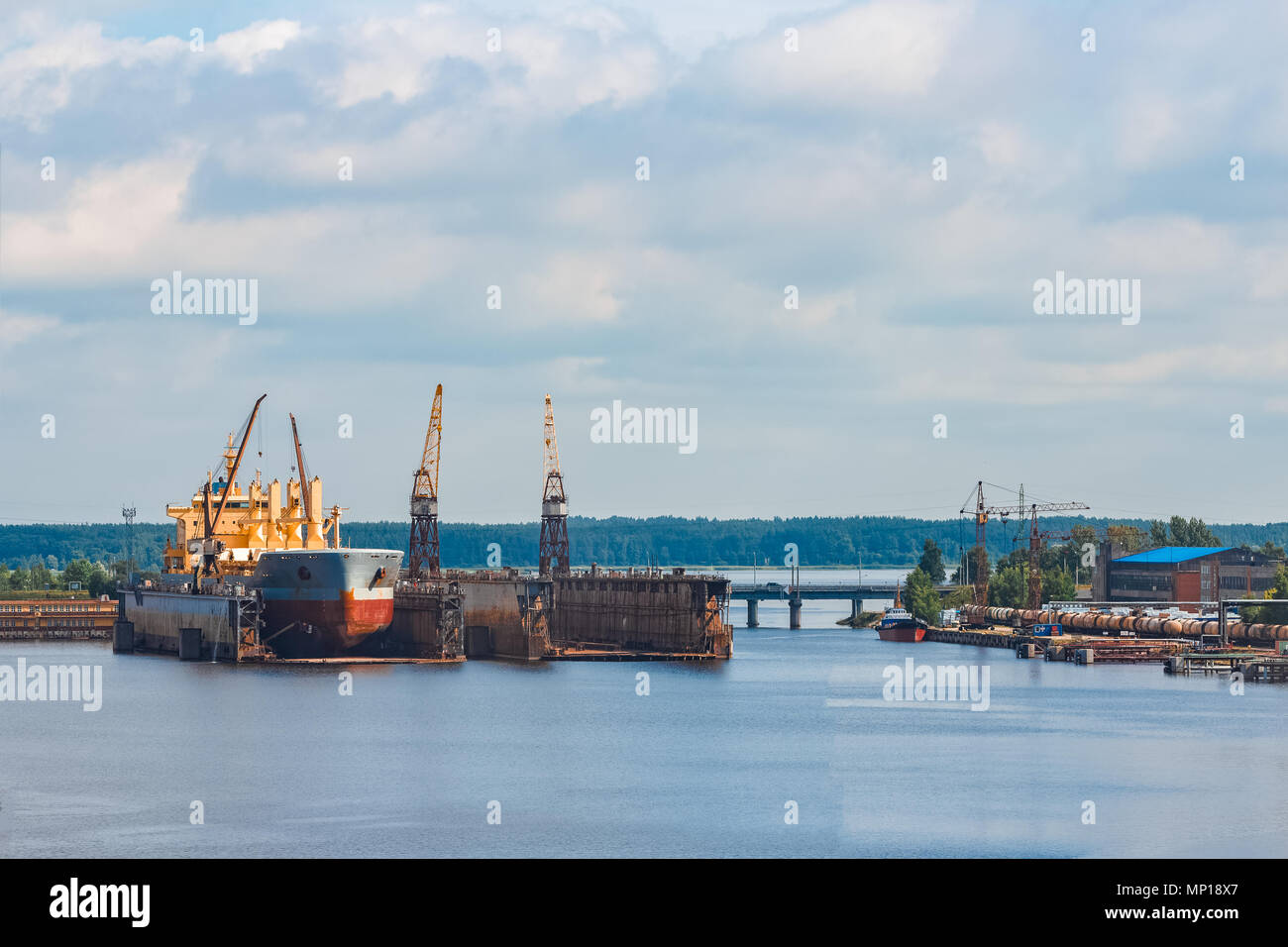 Yellow bulk carrier standing at the old shipyard in the dock Stock ...