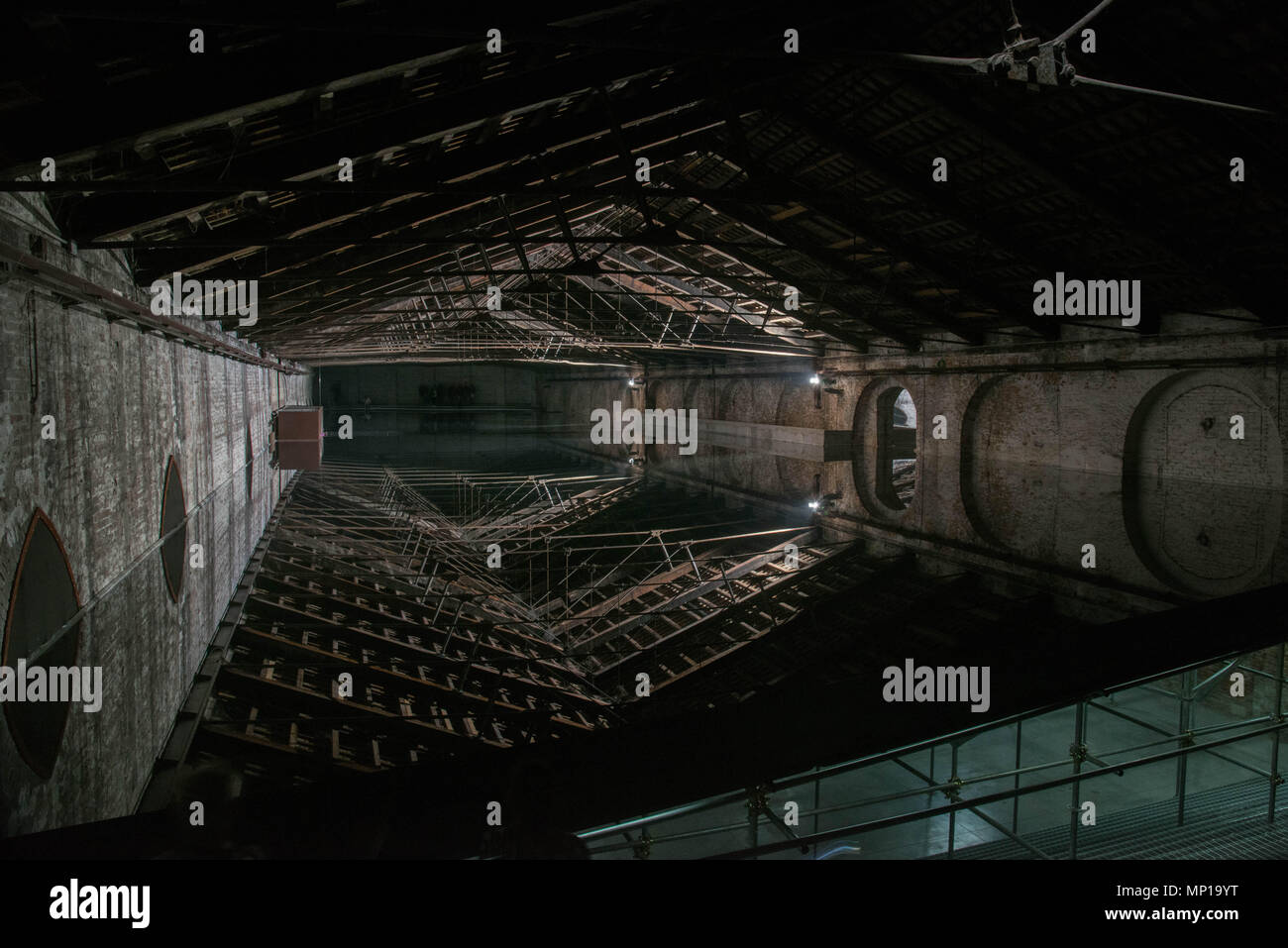 Construction of a wooden roof of an industrial hall. A mirror is placed ...