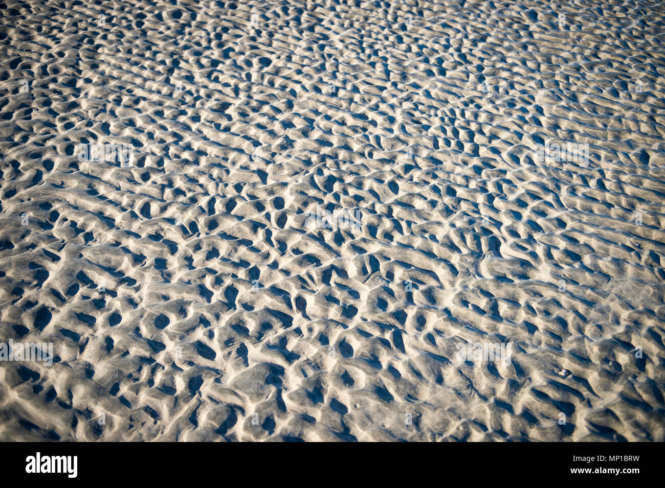 Abstract view of ripple texture left in the sand on a beach at low tide ...