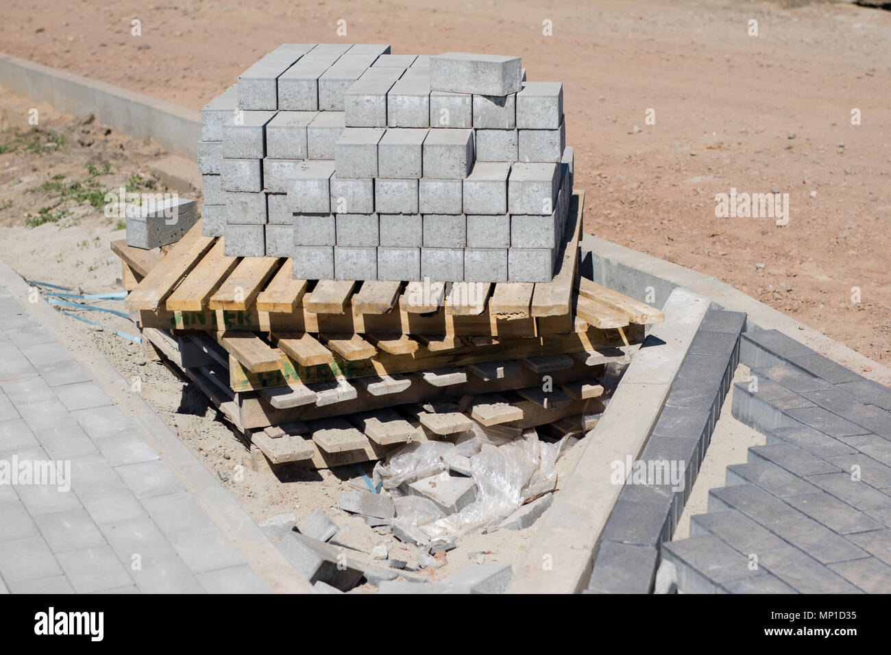 Construction site for a new road for cars. Laying paving blocks, new ...