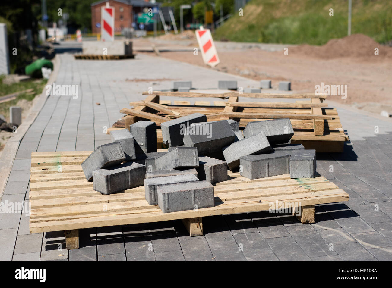 Construction site for a new road for cars. Laying paving blocks, new ...