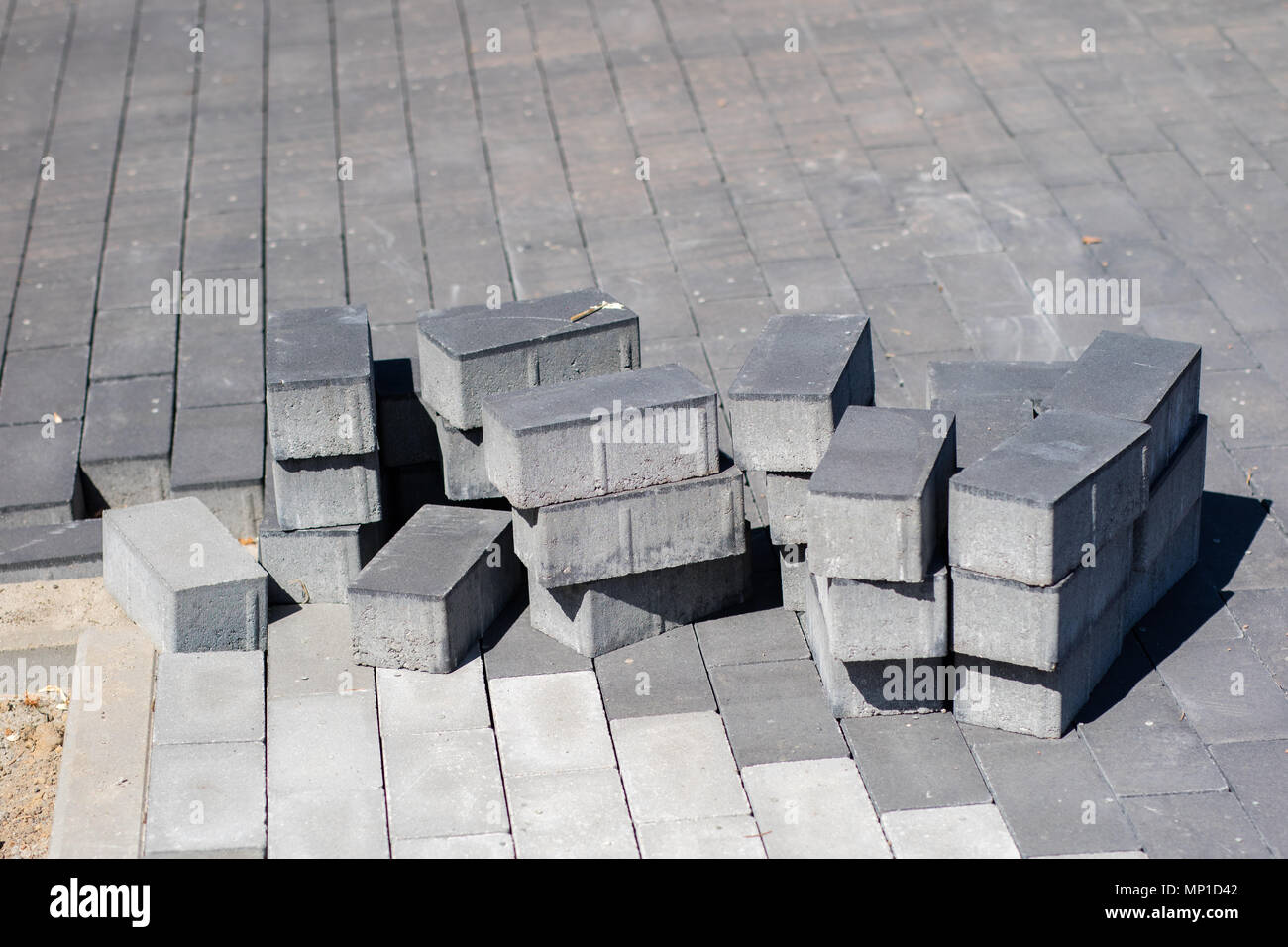 Construction site for a new road for cars. Laying paving blocks, new ...