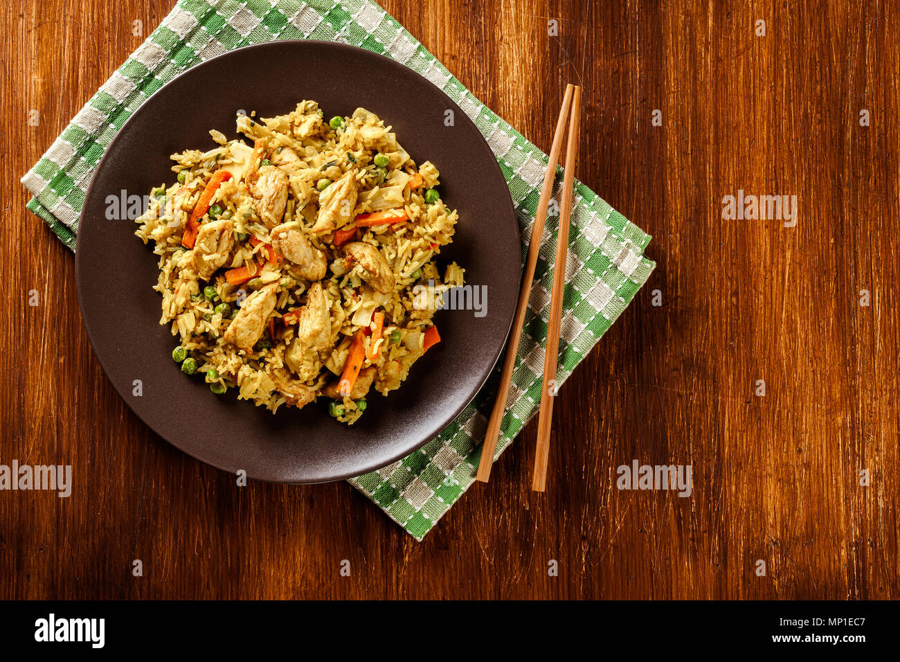 Fried rice nasi goreng with chicken and vegetables on a plate ...