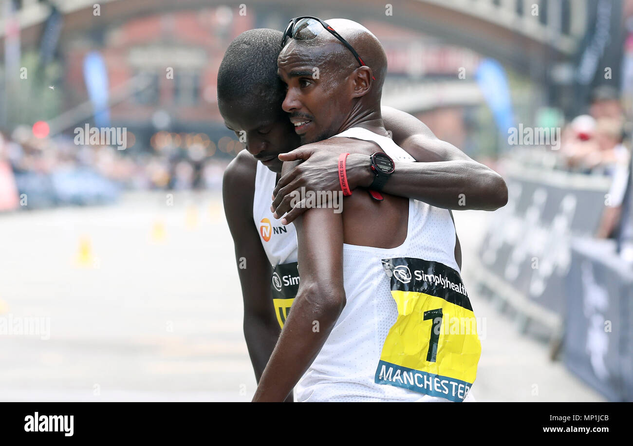 Great Britain's Mo Farah (right) embraces second placed Uganda's Moses Kipsiro after winning the ...
