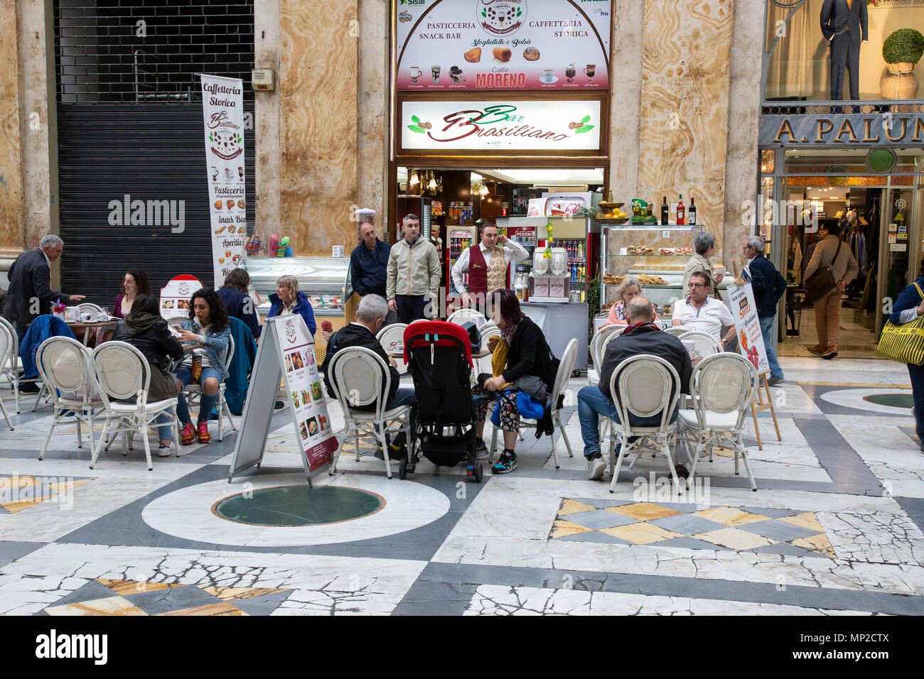 Tourists and locals enjoying a coffee at a typical Italian cafe in ...