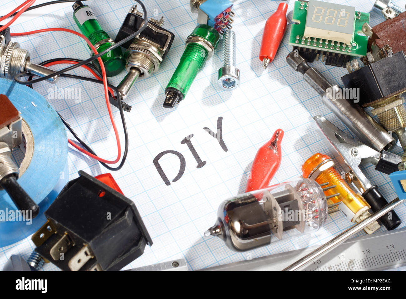 "Do it yourself" - radio-electronic parts on graph paper background ...