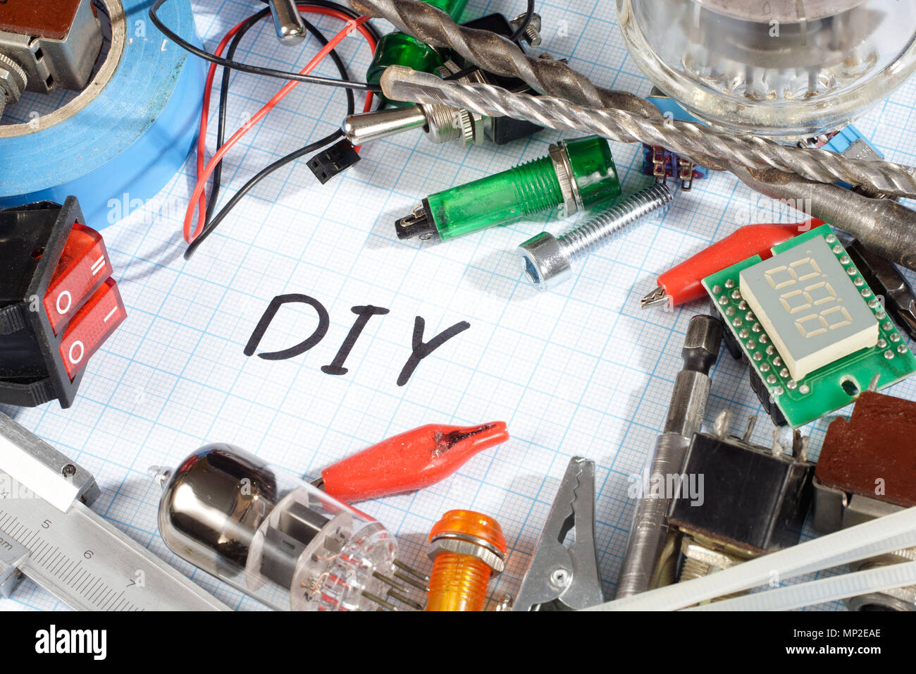 "Do it yourself" - radio-electronic parts on graph paper background ...