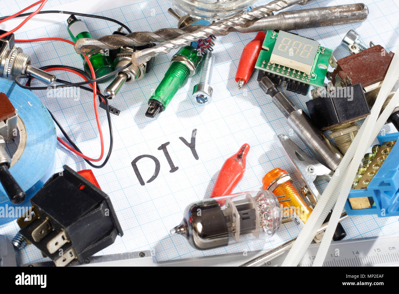 "Do it yourself" - radio-electronic parts on graph paper background ...
